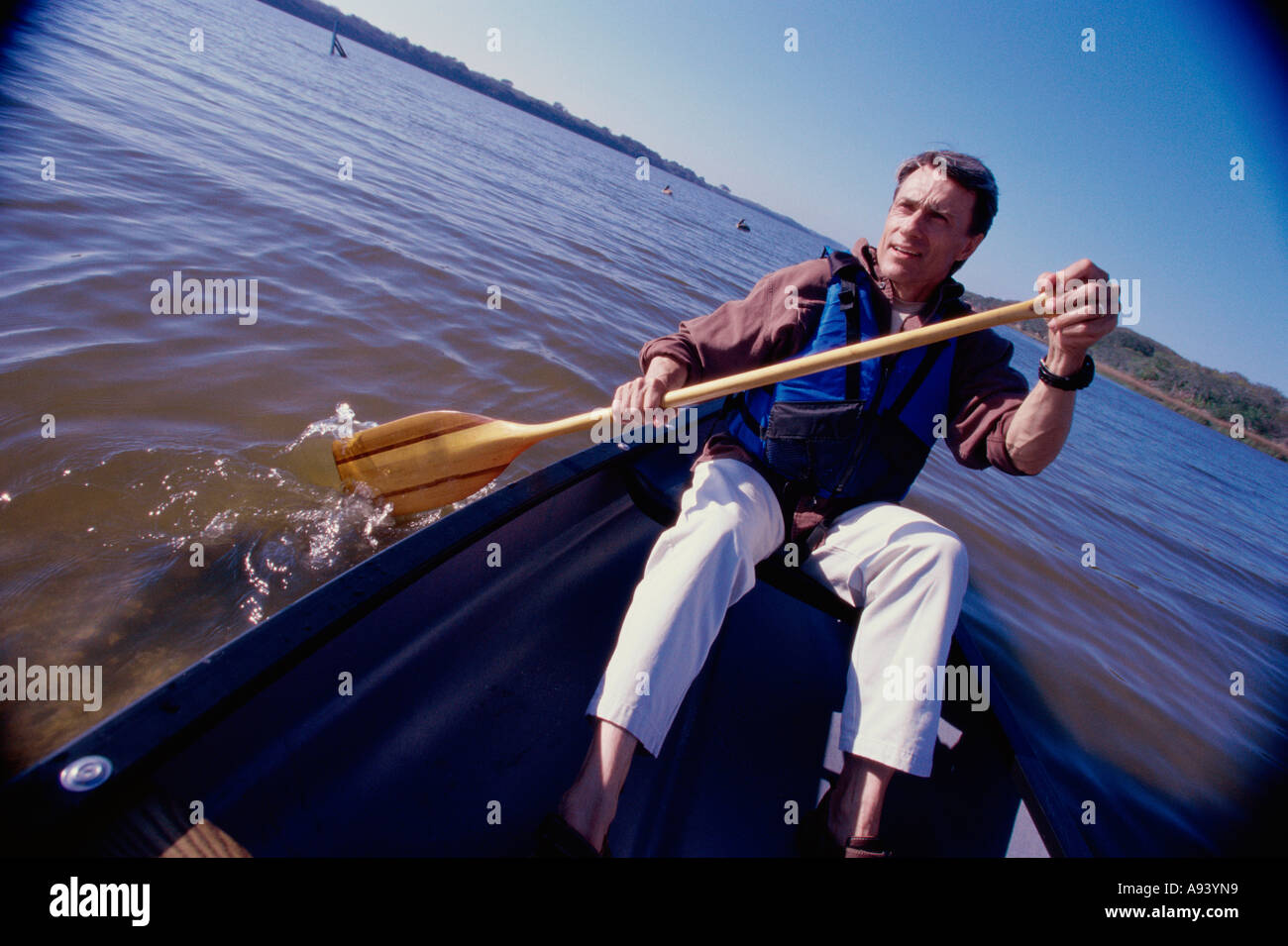 Mid adult man rowing a boat Stock Photo - Alamy