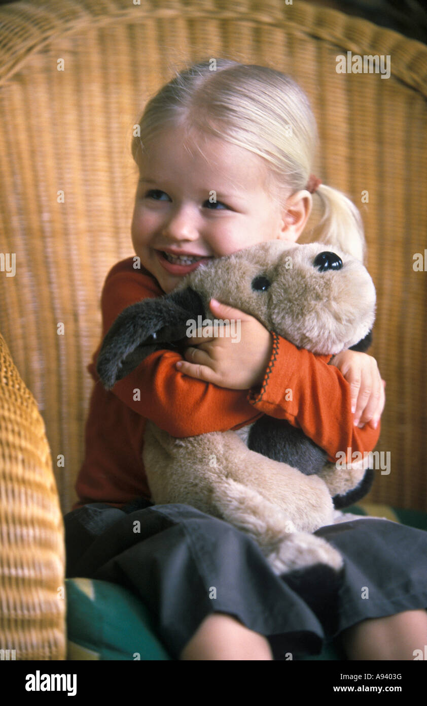Little girl hugging her pet toy Stock Photo - Alamy