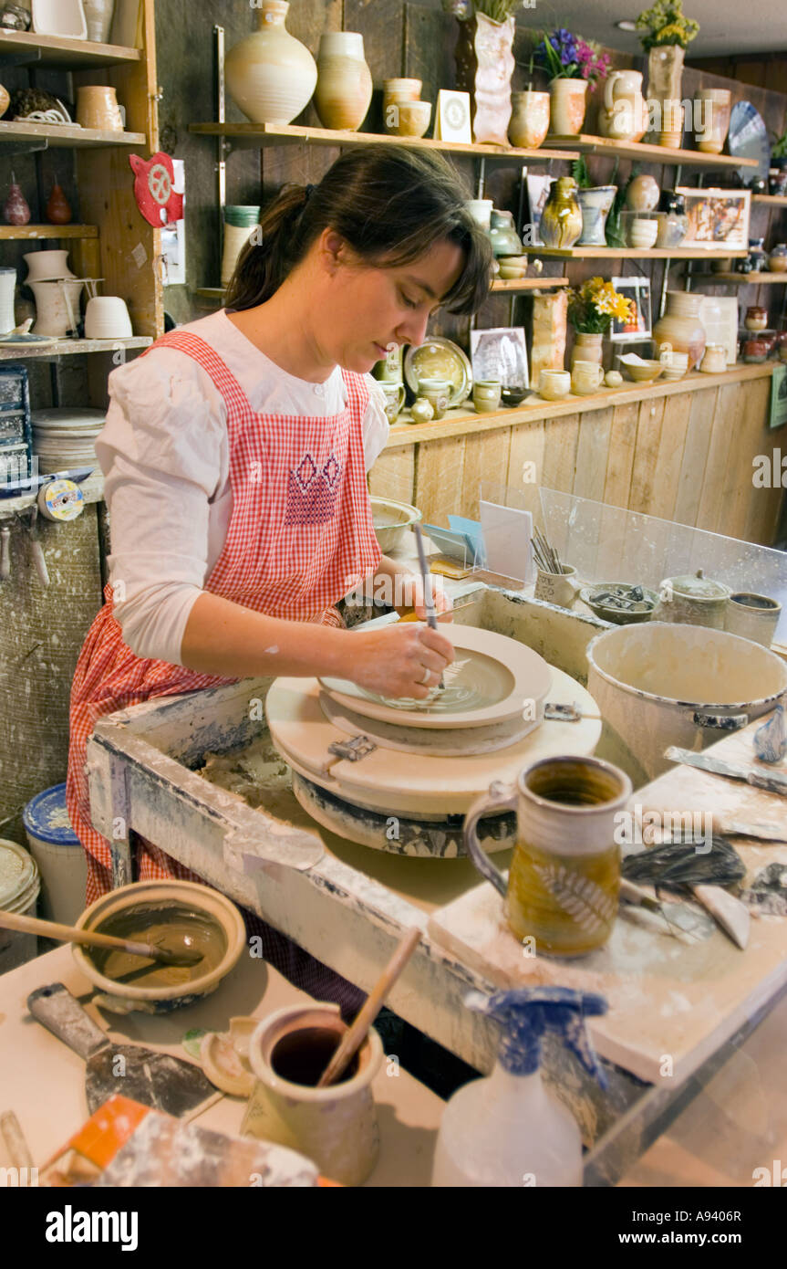 Potter making traditional pottery in the Crafts Village at the Ozark ...