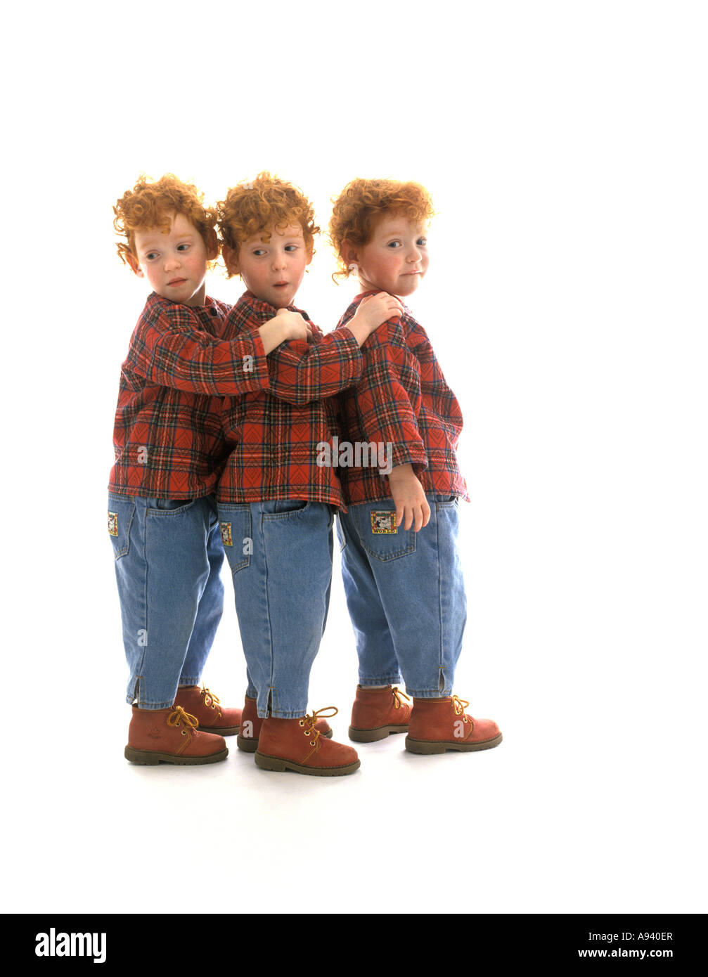 Triplet with red hair on white background Stock Photo - Alamy