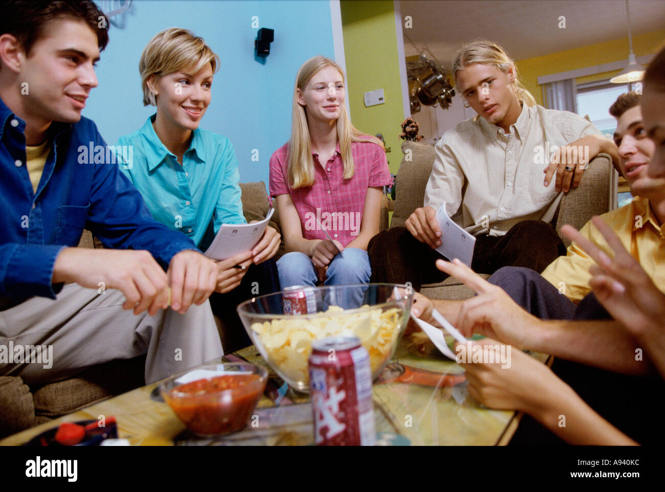 Three teenage boys and two teenage girls playing a board game Stock ...
