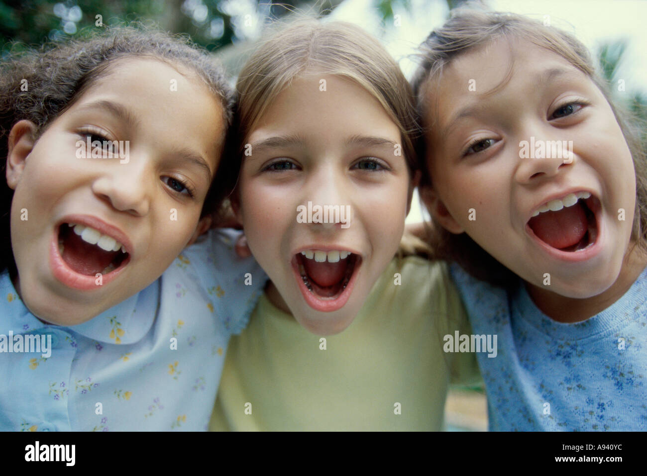 Portrait of three girls shouting Stock Photo - Alamy