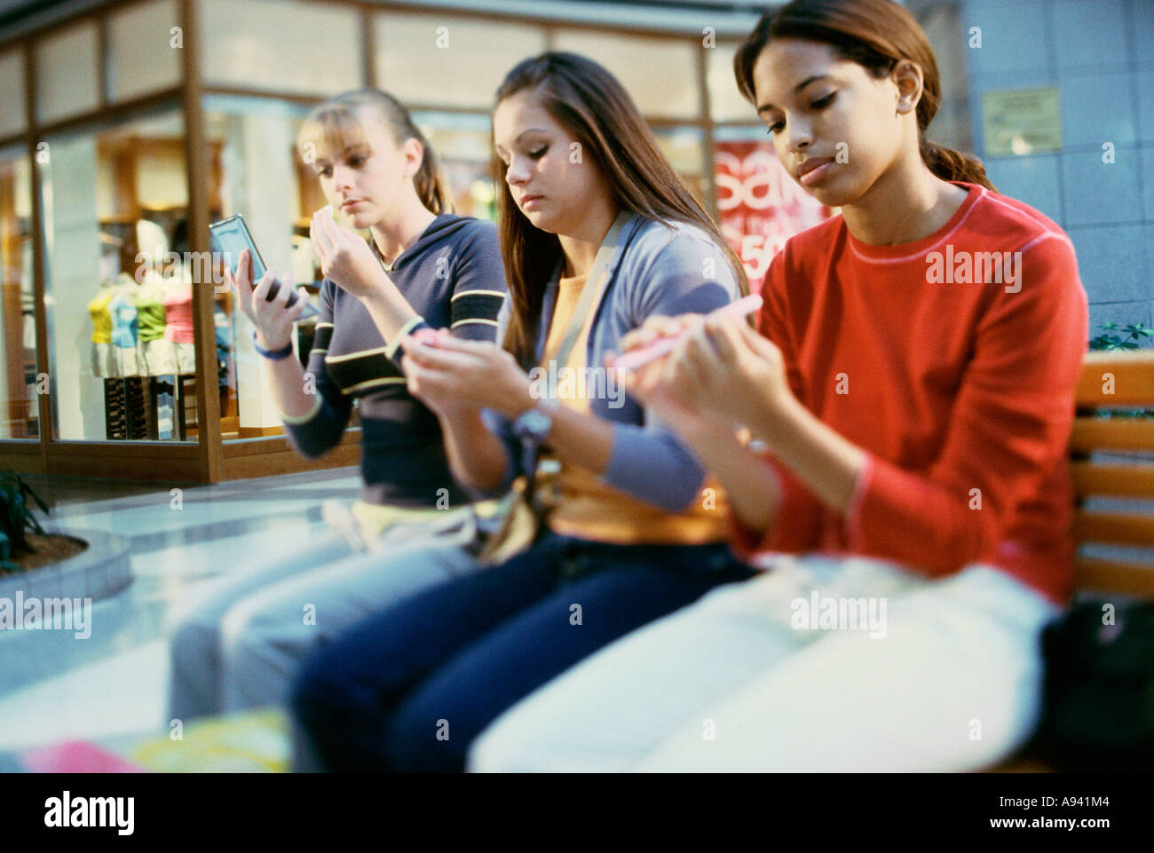 Three teenage girls grooming themselves Stock Photo - Alamy