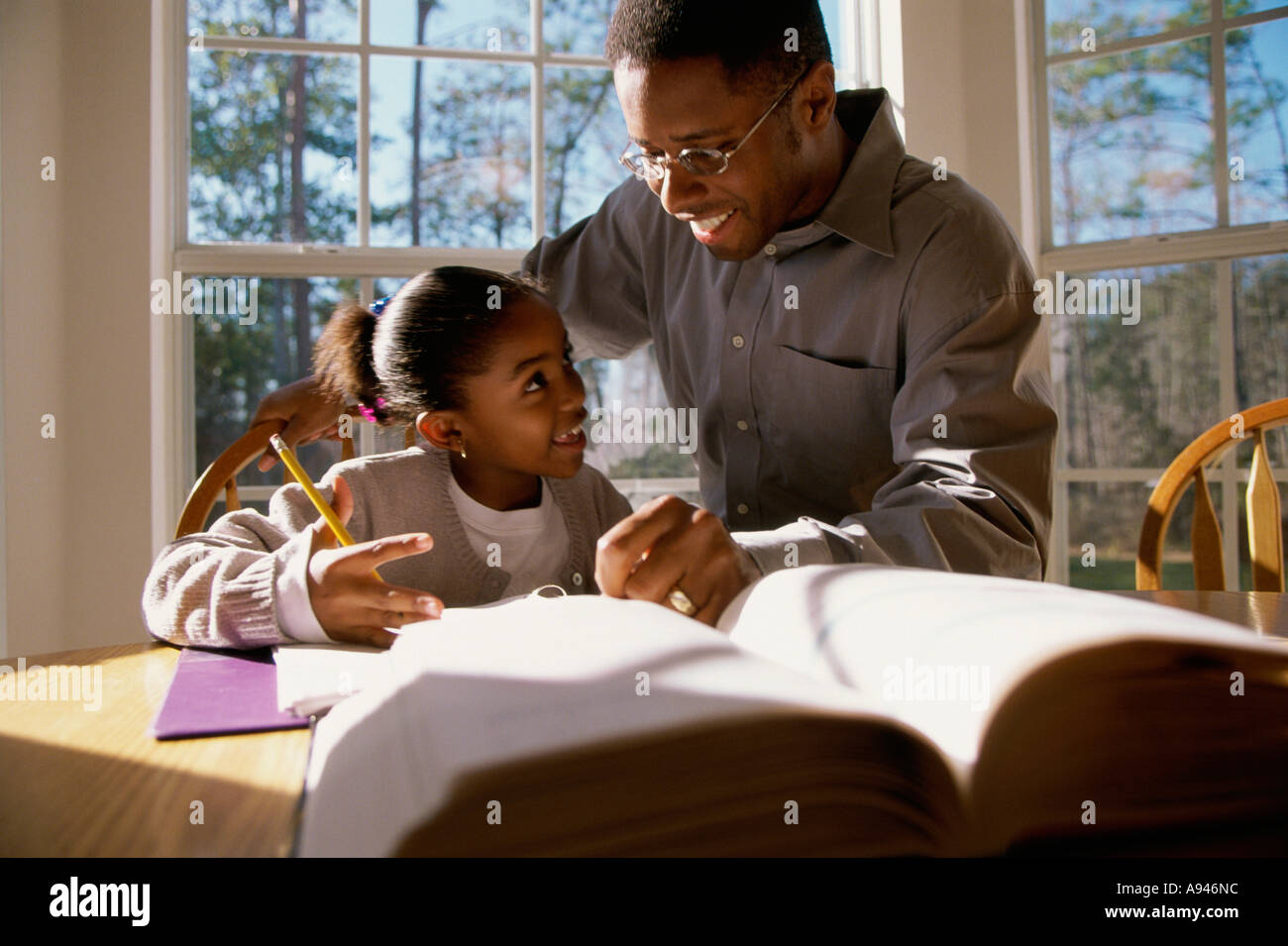Father helping his daughter with her homework Stock Photo - Alamy