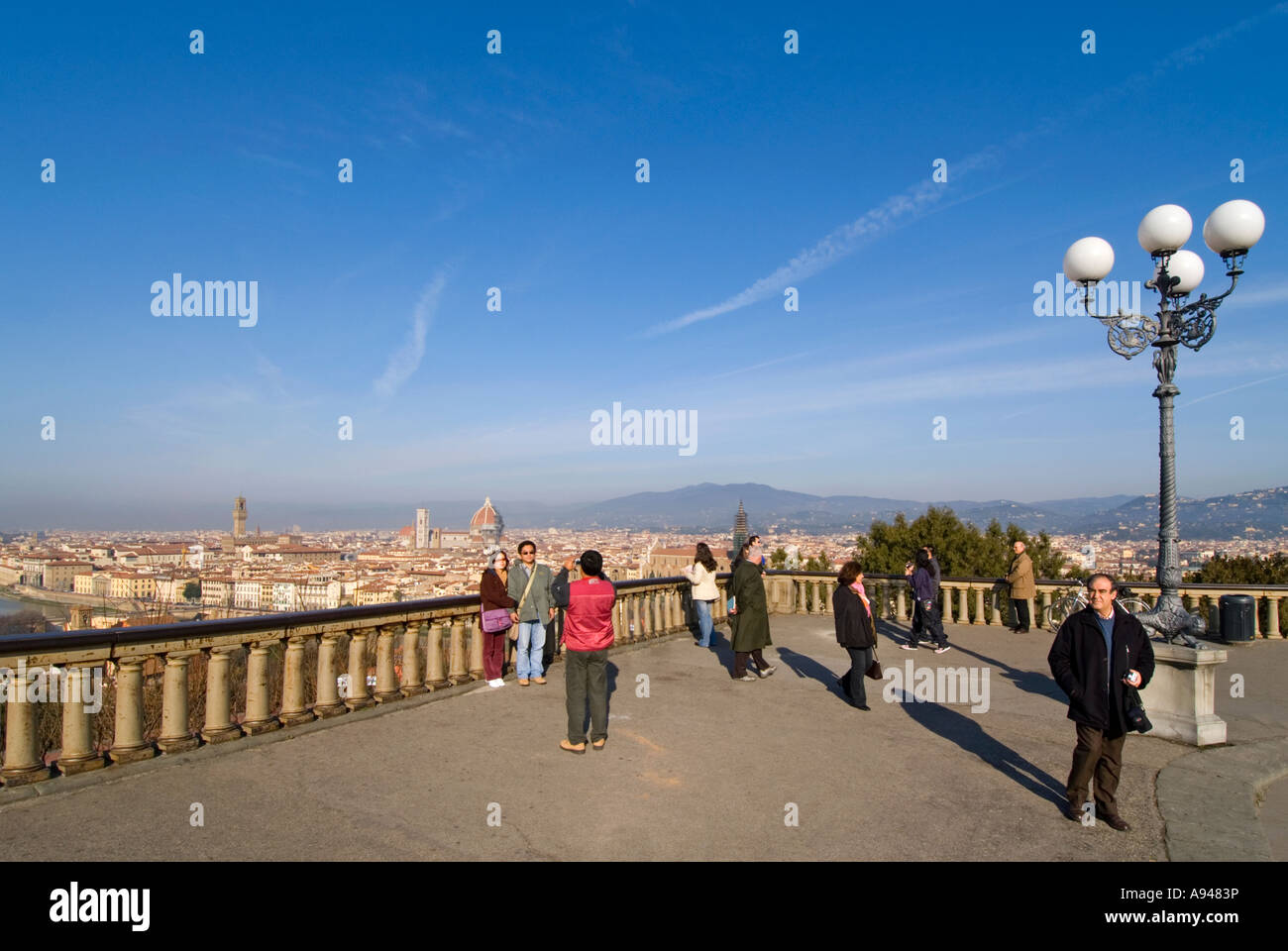 Horizontal wide angle of tourists enjoying the views across historical ...
