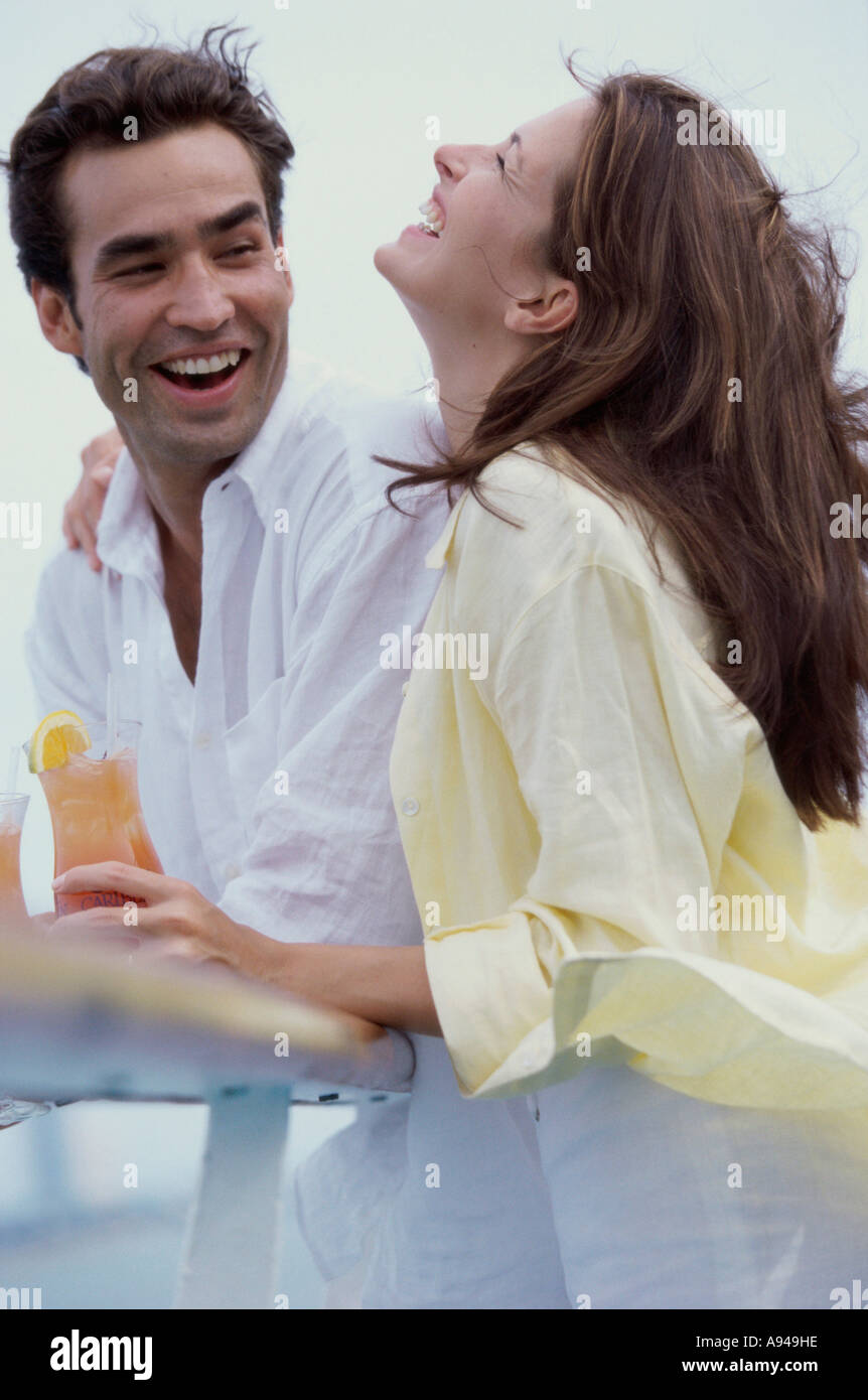 Side profile of a mid adult couple laughing Stock Photo - Alamy