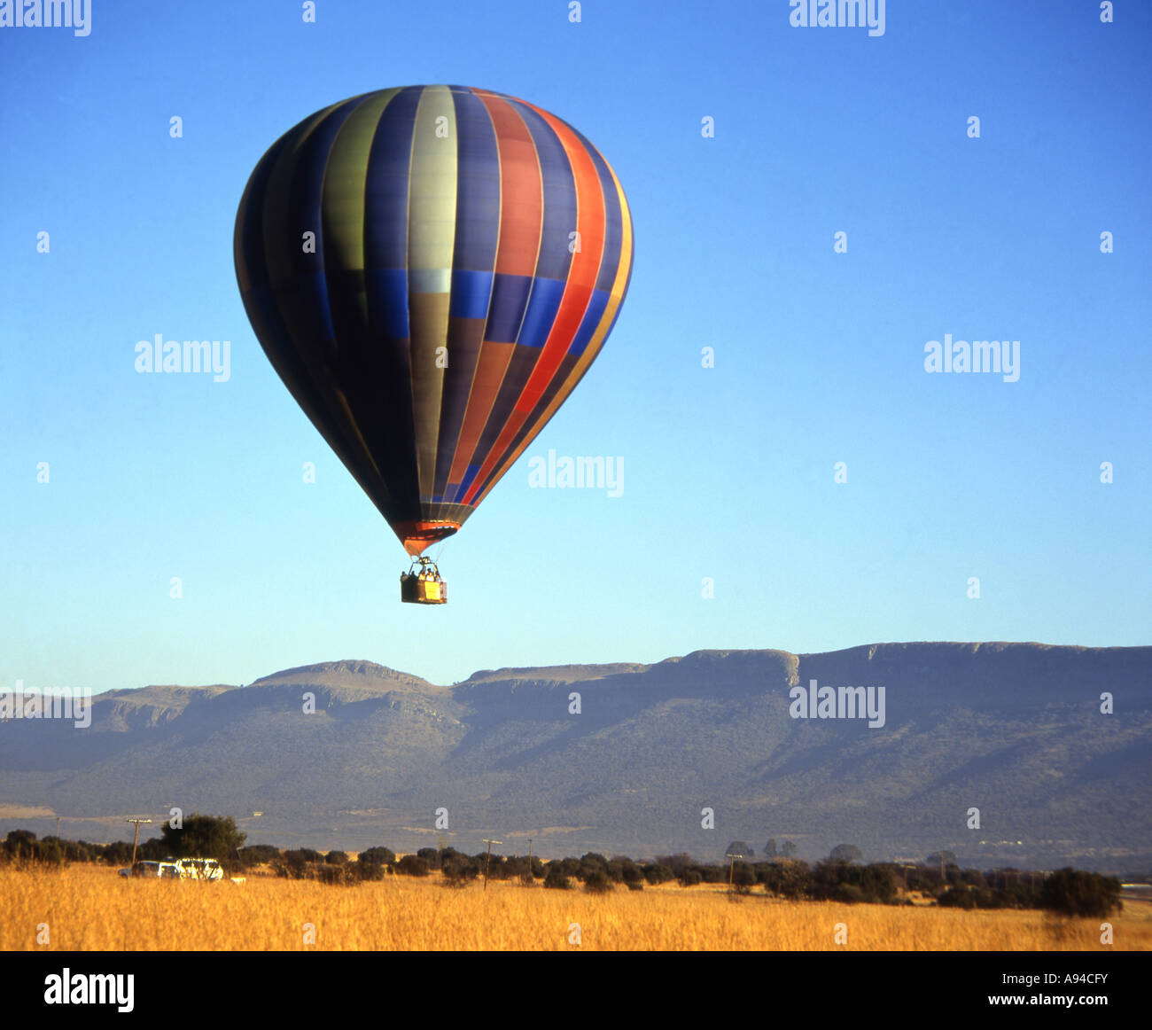 Sightseers on a hot air balloon ride with the Magaliesberg ridge in the ...