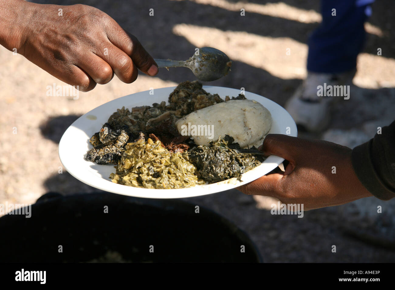 Plates being loaded with traditionally prepared food at Letlhafula day ...