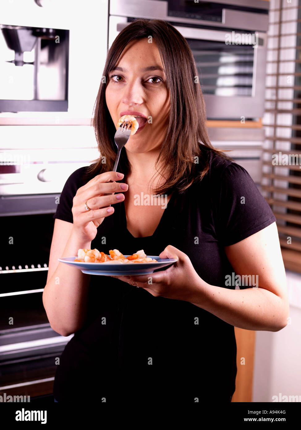 Woman Eating Prawns Model Released Stock Photo - Alamy