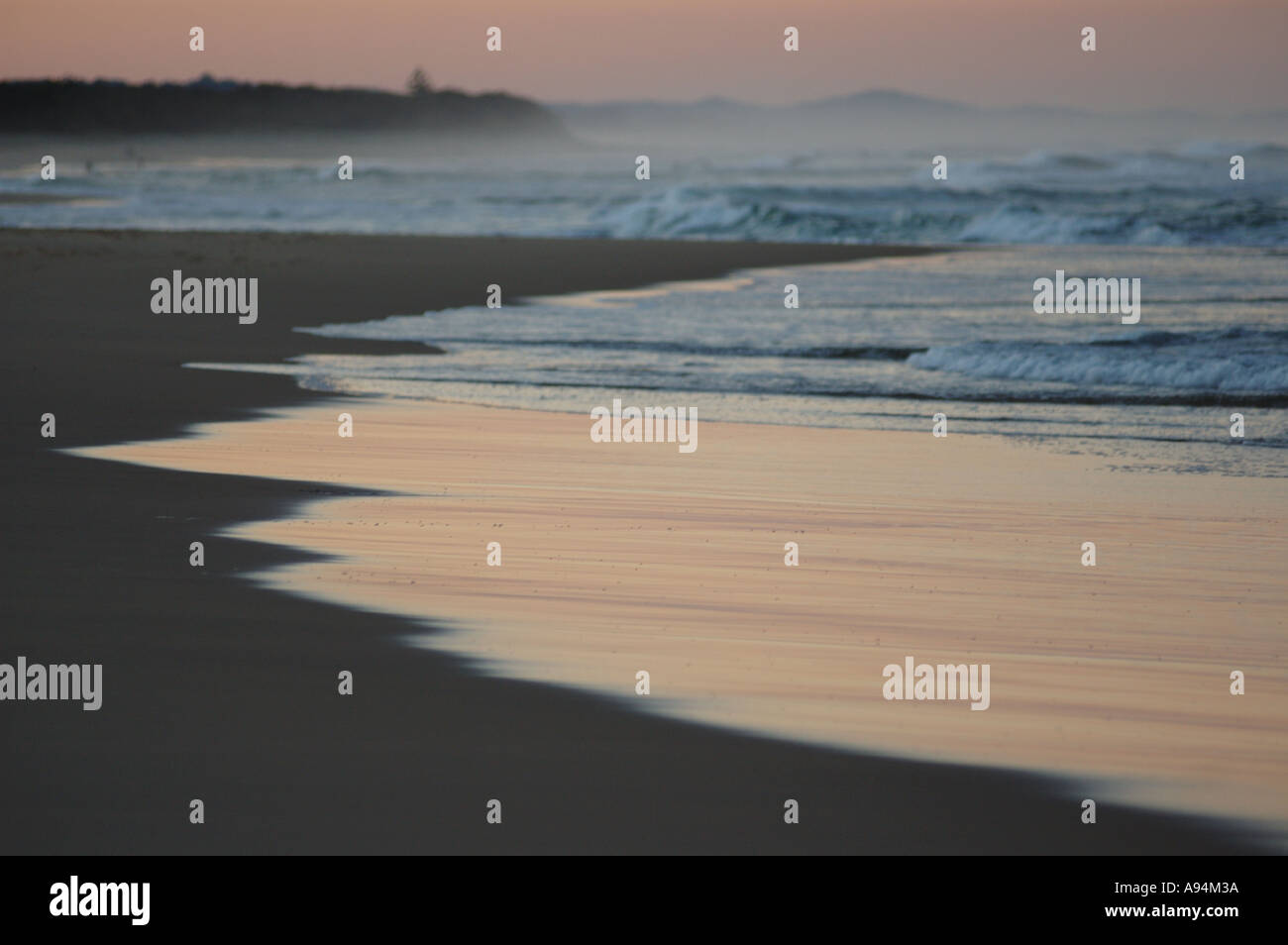 shine sheen of receding wave on beach Stock Photo - Alamy