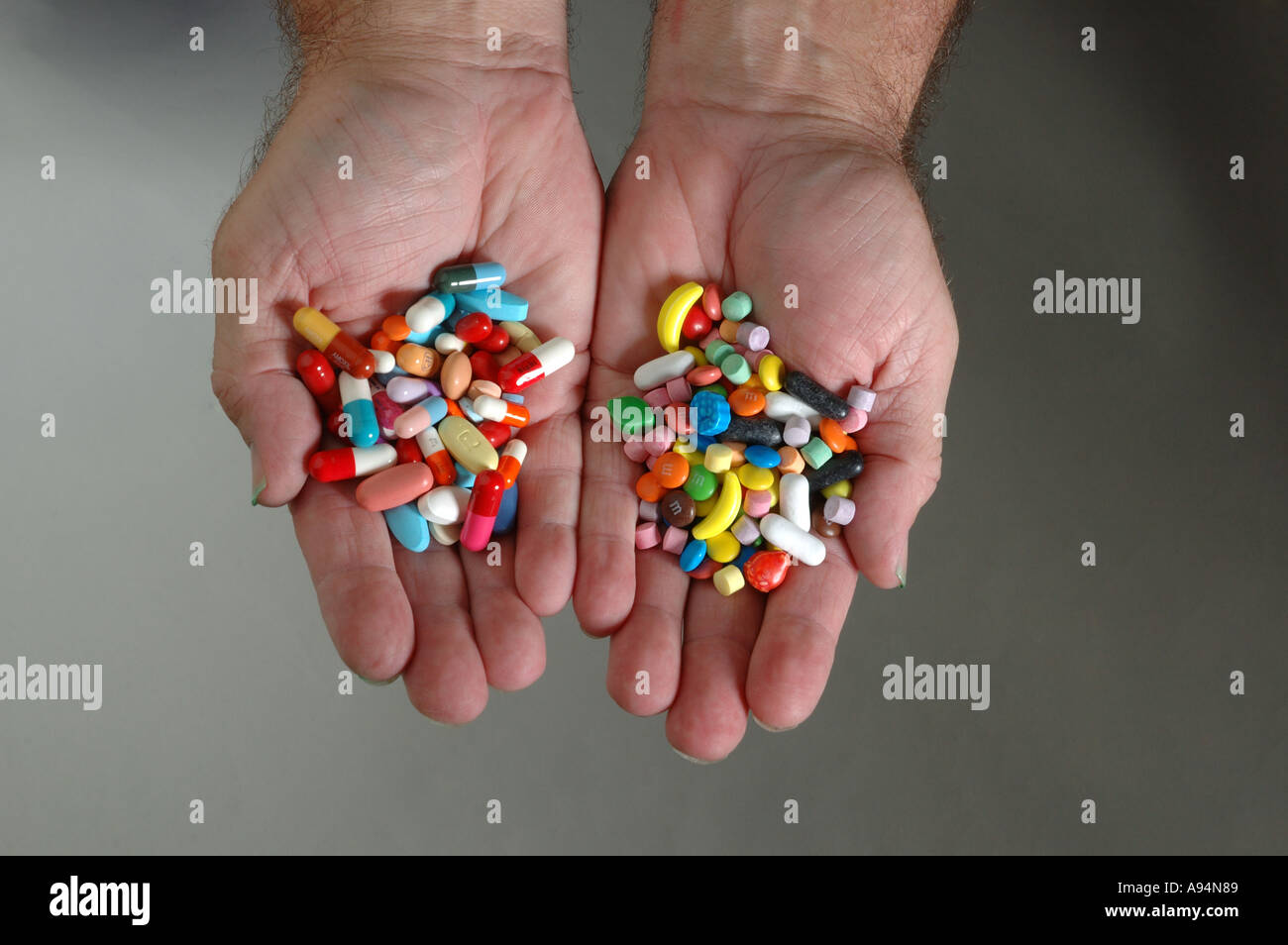 comparison between candy and drugs held in two 2 male hands dsca 3182 ...