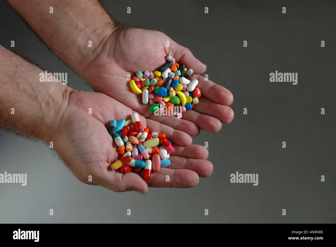 comparison between candy and drugs held in two 2 male hands dsca 3182 ...