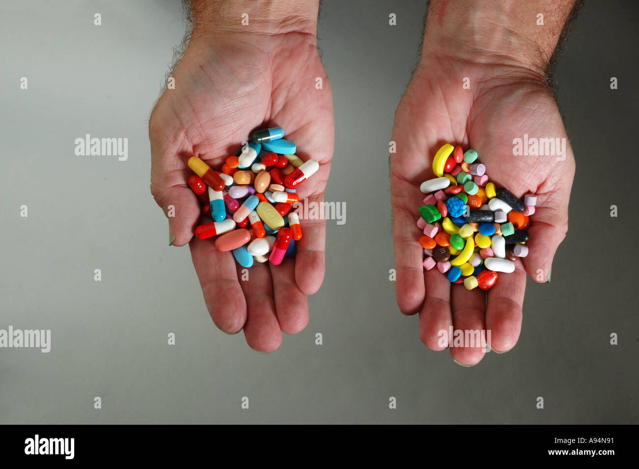 comparison between candy and drugs held in two 2 male hands dsca 3182 ...