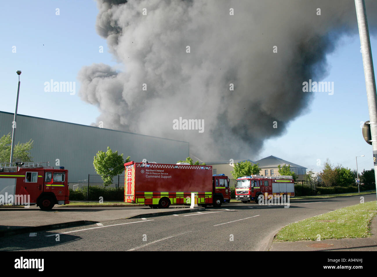 fire service control vehicle beneath plume of smoke and falling debris ...