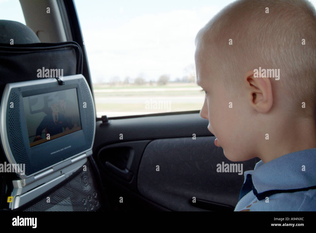 boy watching DVD Player inside car Stock Photo - Alamy
