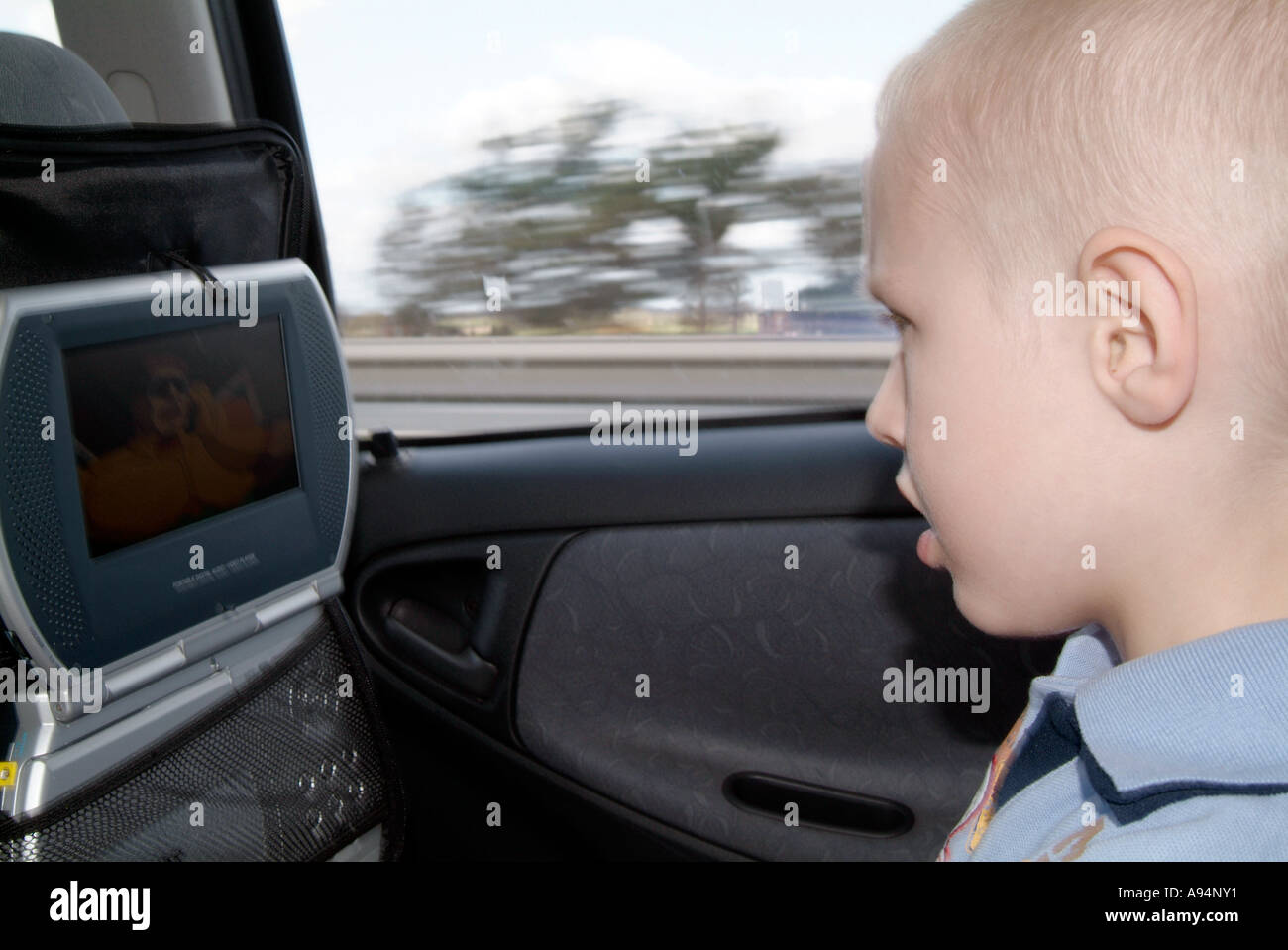 boy watching DVD Player inside car Stock Photo - Alamy