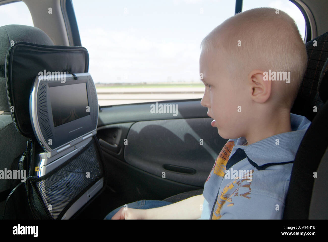 Boy watching DVD Player inside car Entertainment Stock Photo - Alamy