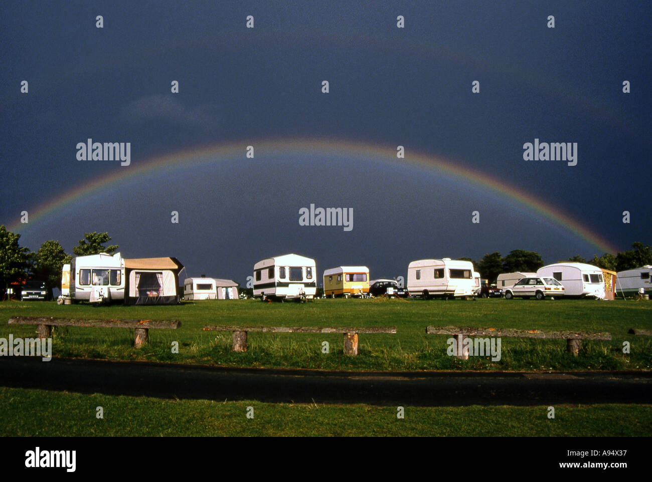 Full arc of rainbow over caravans at a campsite in summer Stock Photo ...
