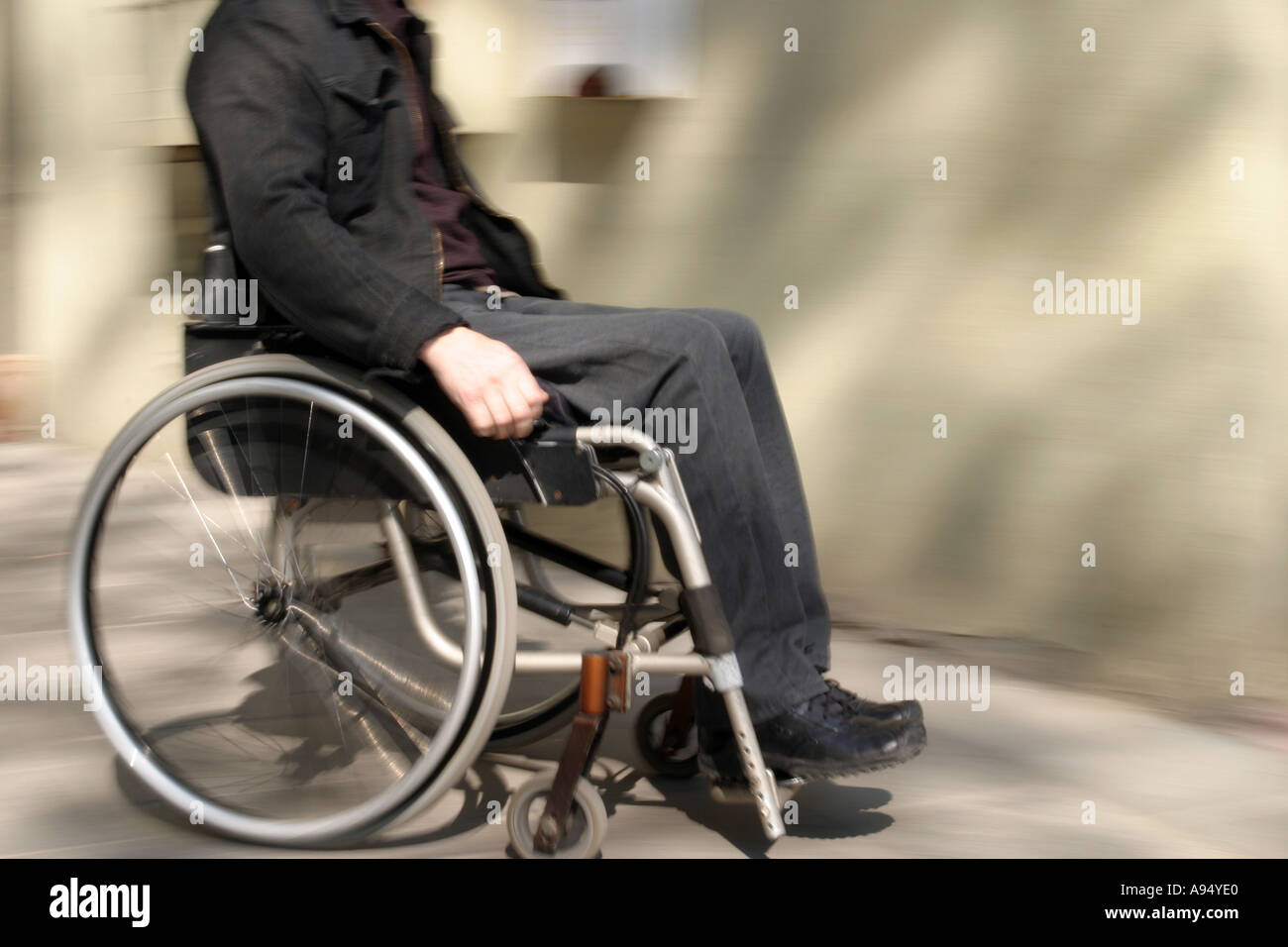 Disabled young man in wheelchair. Blurred motion showing movement Stock ...