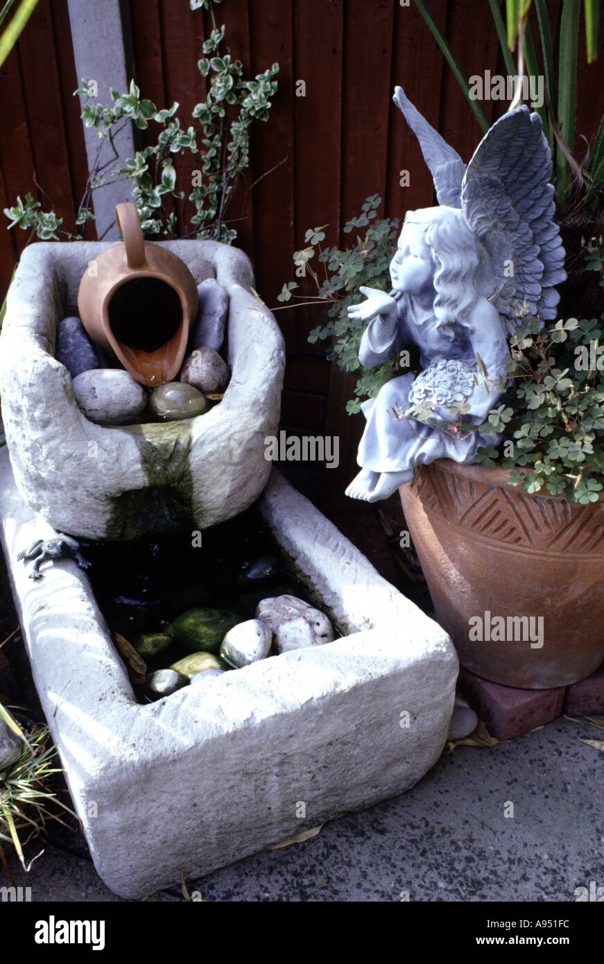 Stone water trough water feature with Angel Statue Stock Photo - Alamy