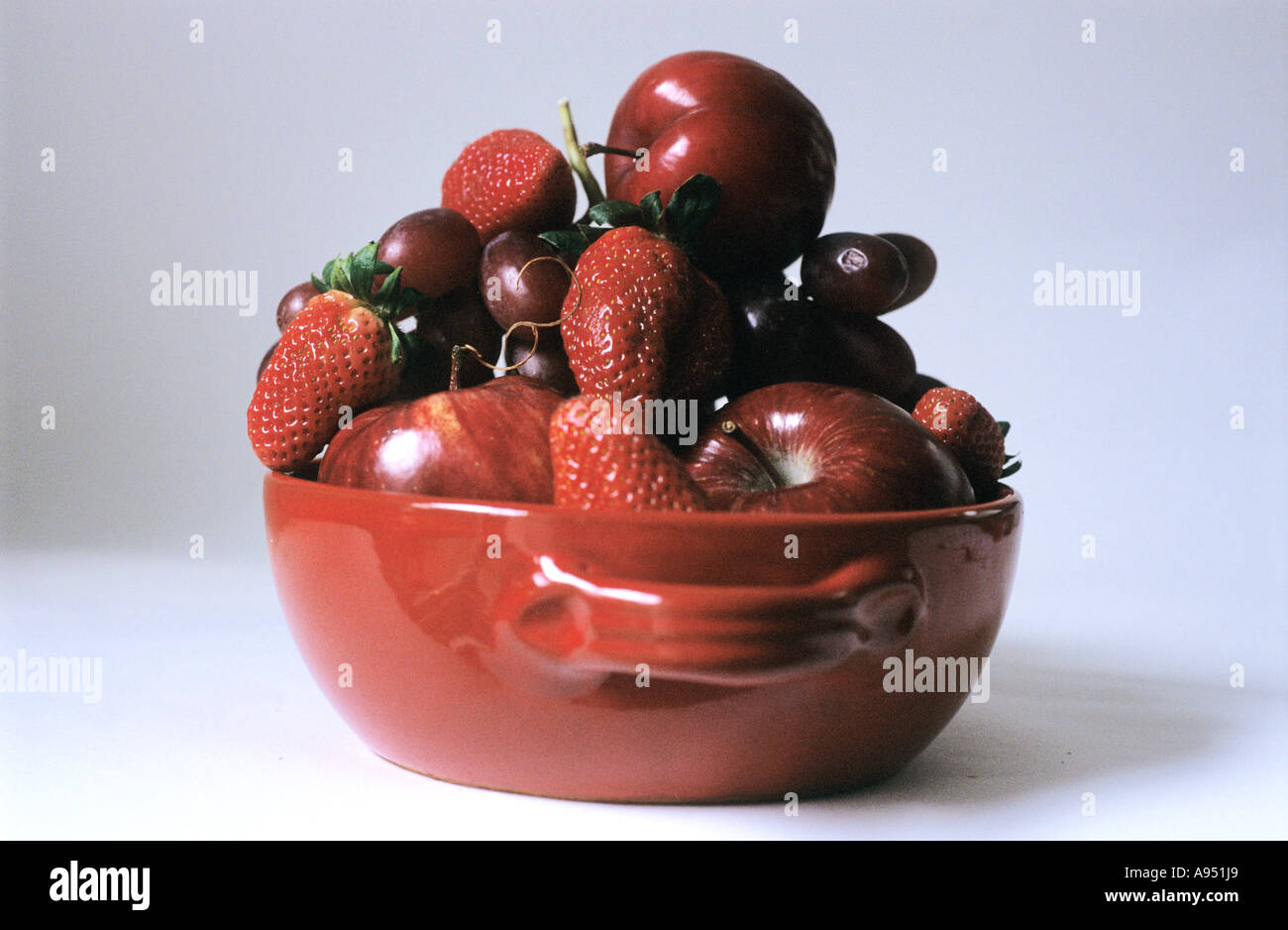 Red fruit Red bowl Stock Photo - Alamy