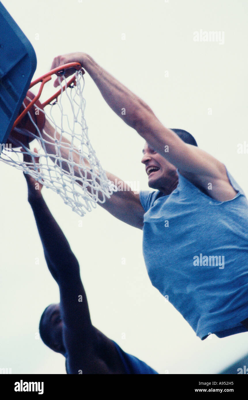 Man dunking basketball low angle hi-res stock photography and images ...