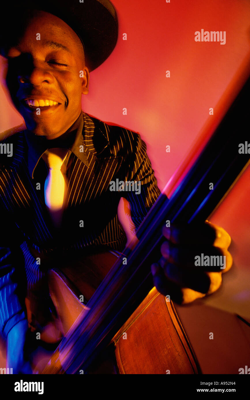 Close-up of a male musician playing a bass Stock Photo - Alamy