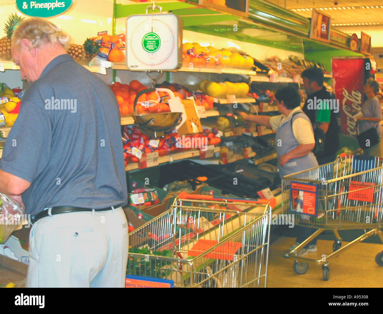 Shopping in supermarket aisle Stock Photo - Alamy
