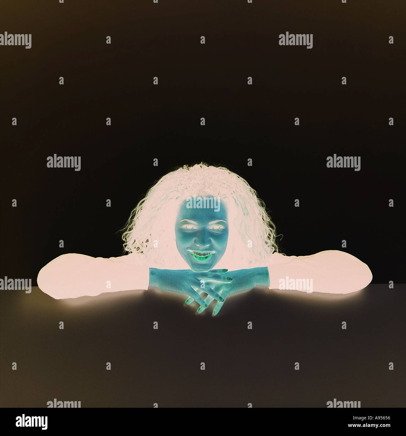 Photograph of woman looking over wall Stock Photo - Alamy