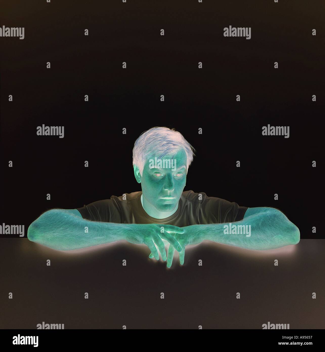 Photograph of man looking over wall Stock Photo - Alamy