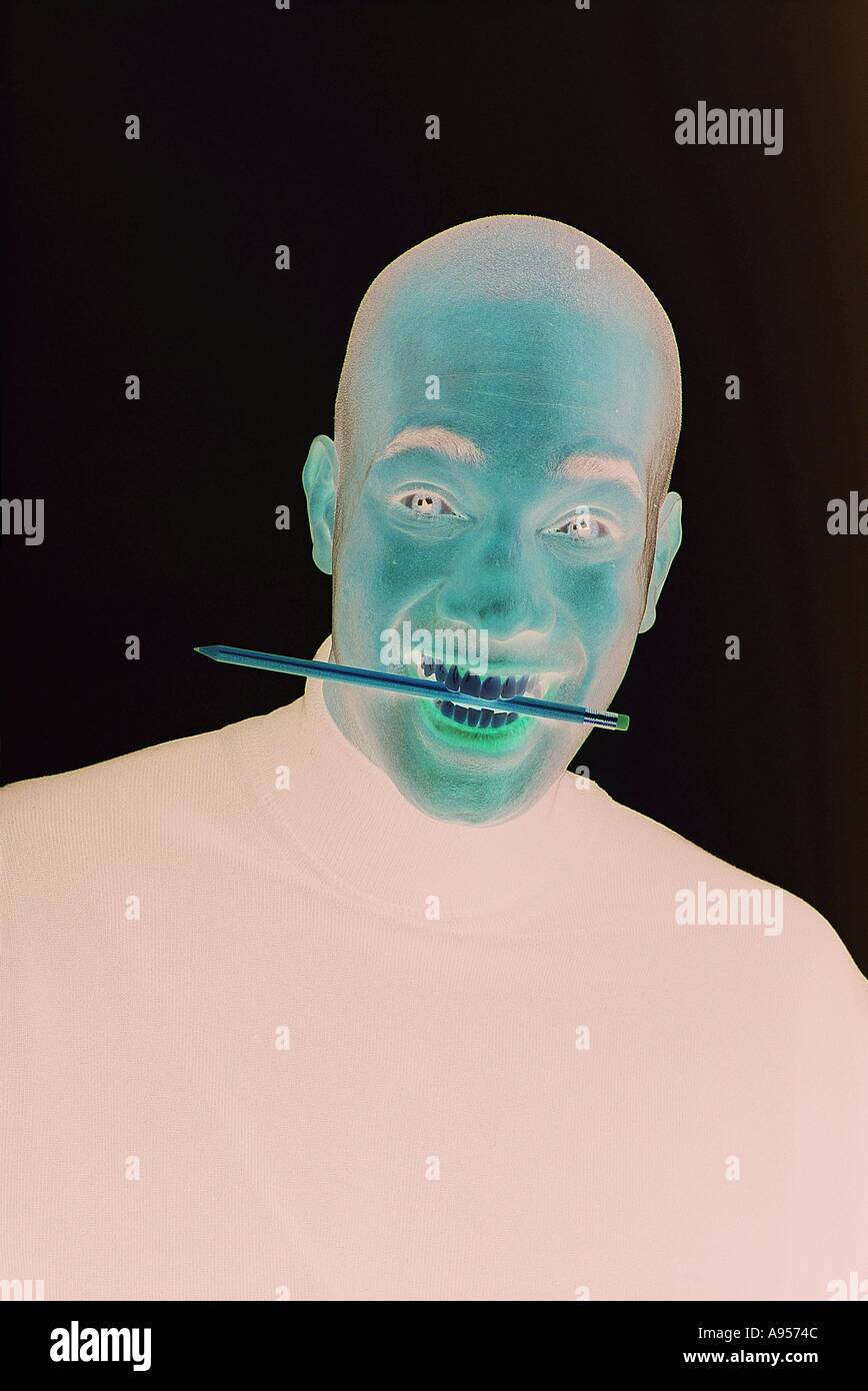 Photograph of man with pencil in mouth Stock Photo - Alamy