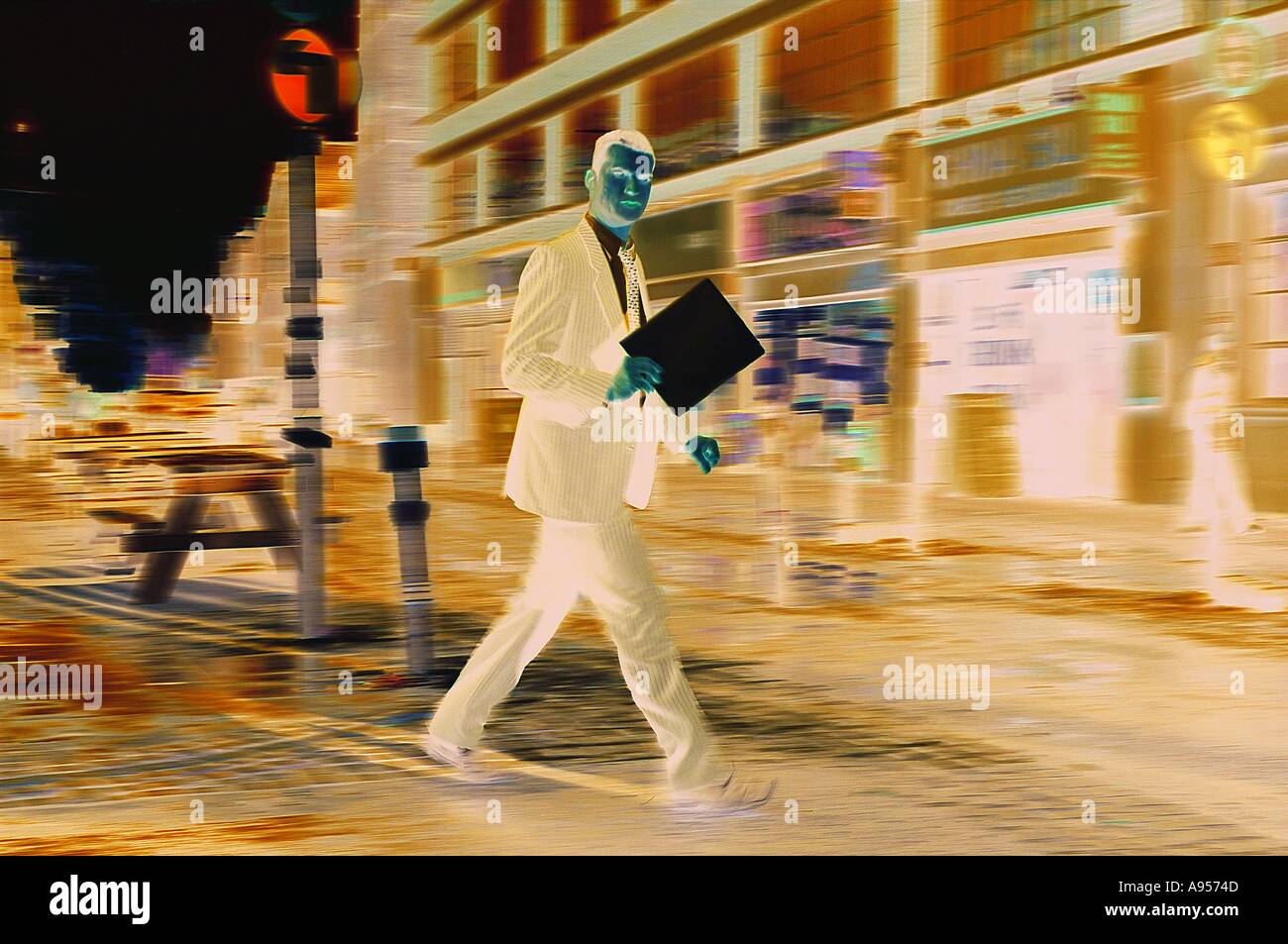 Photograph of man walking in city street carrying a document Stock ...