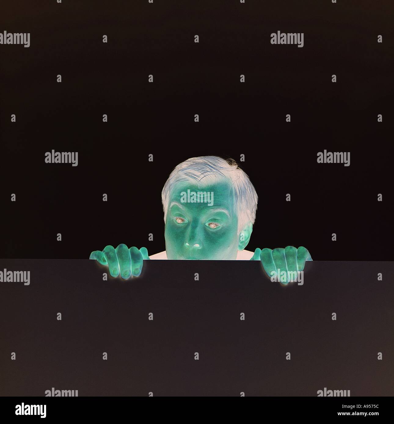 Photograph of man looking over wall Stock Photo - Alamy