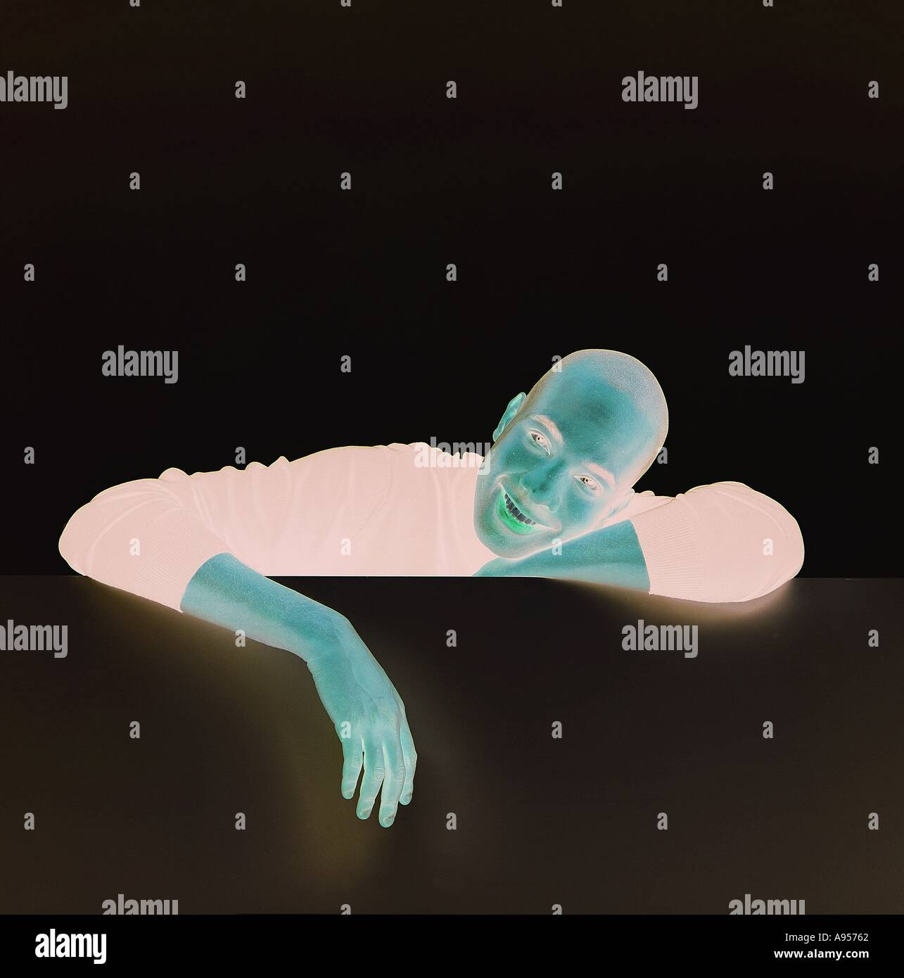 Photograph of man resting on top of wall Stock Photo - Alamy