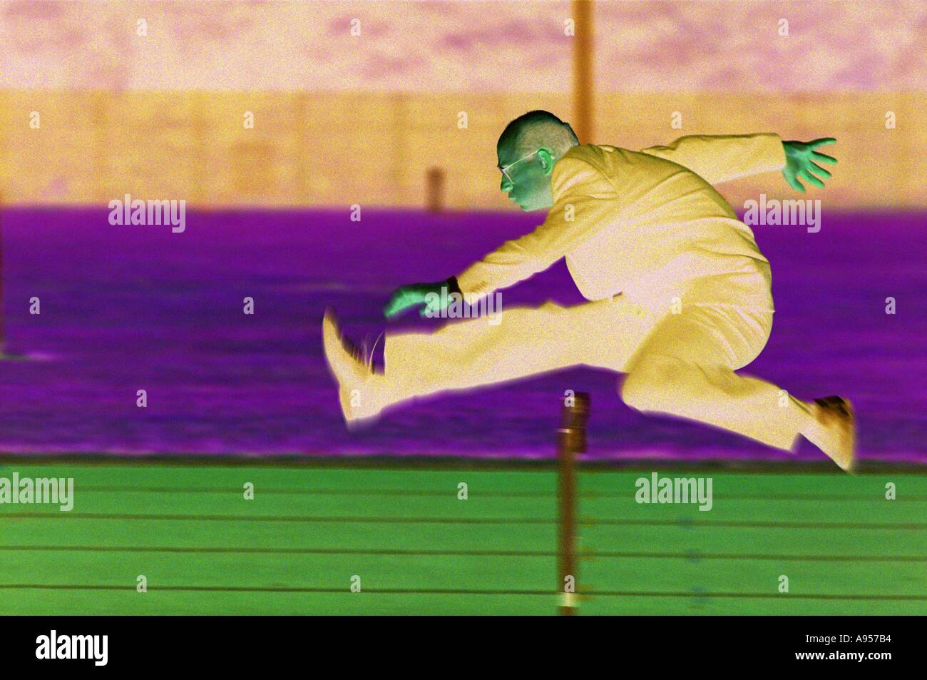 Photograph of suited man jumping running track hurdles Stock Photo - Alamy