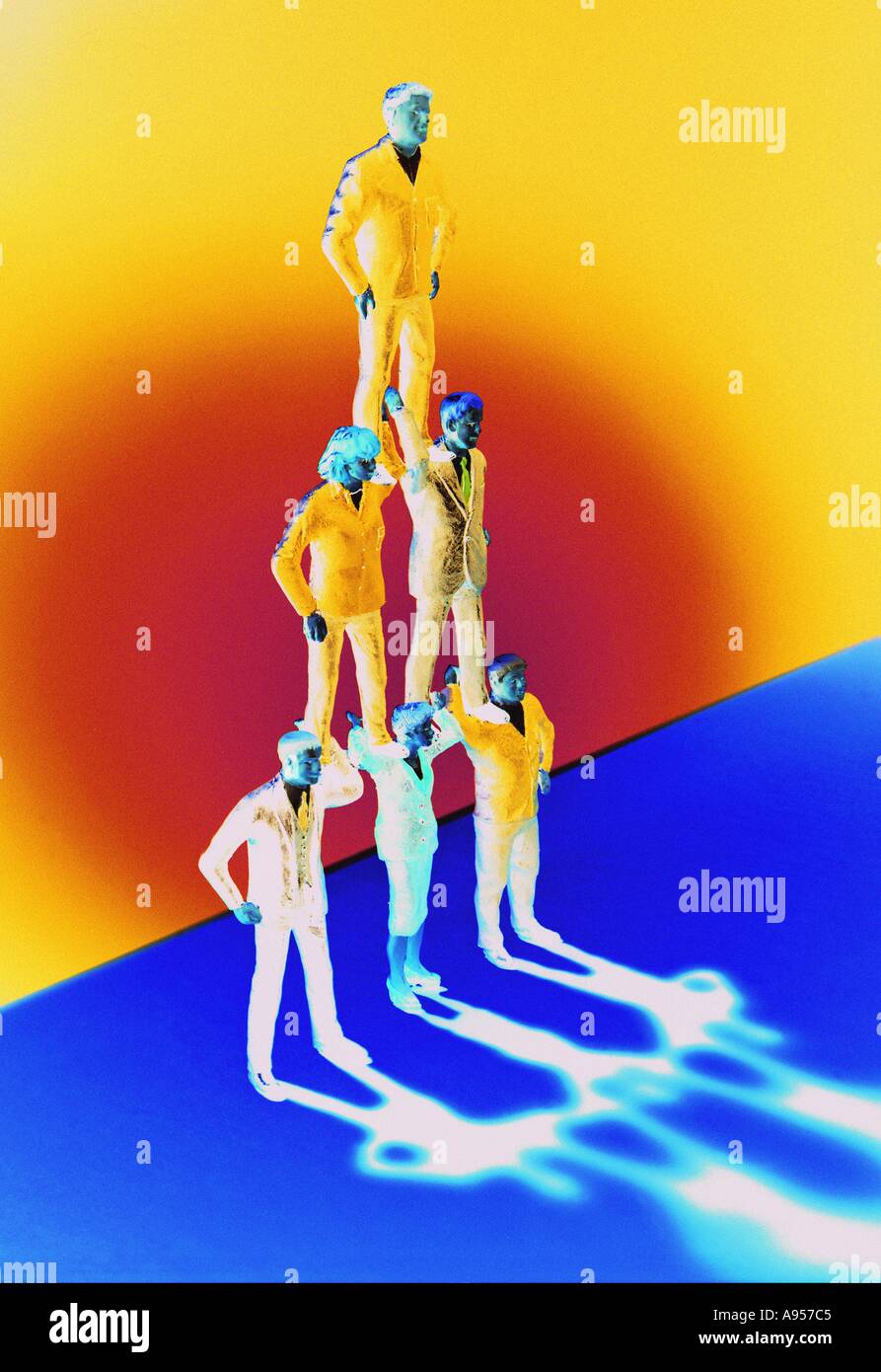 Photograph of model people making human pyramid Stock Photo - Alamy