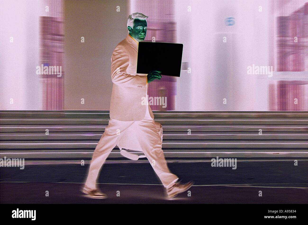 Photograph of man walking in city street holding sign or document Stock ...