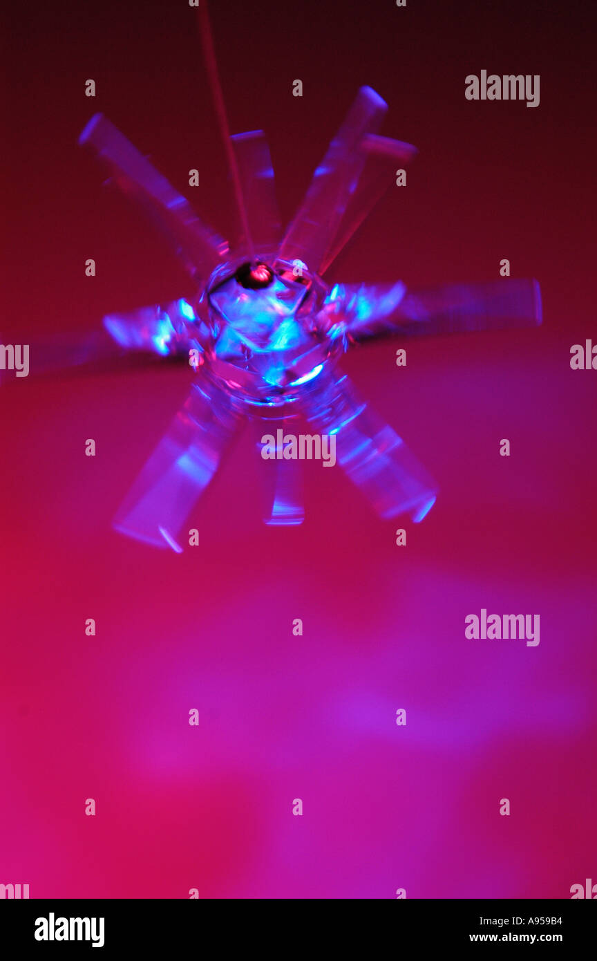 Illuminated blue star light, swinging and blurred with movement ...