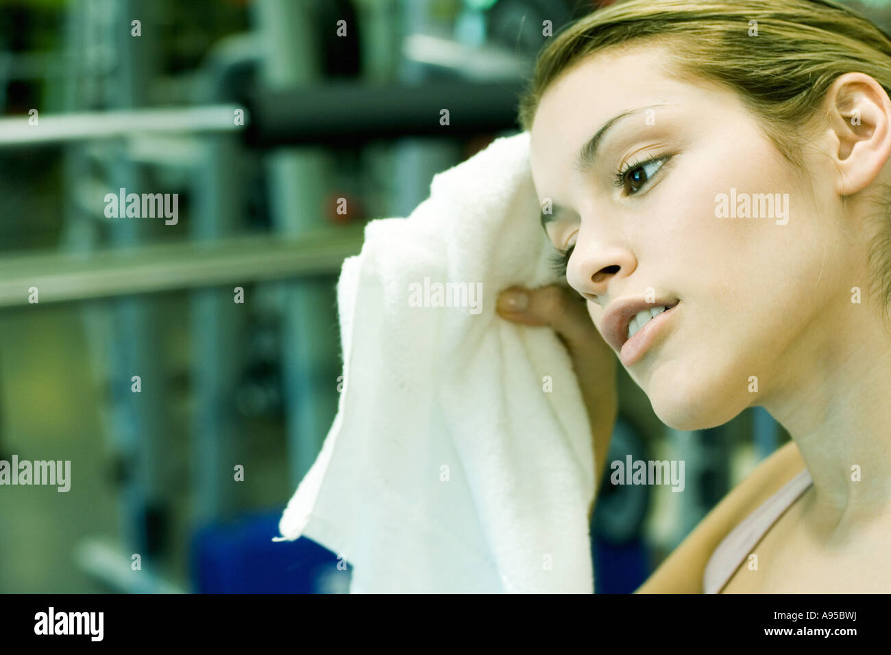 Young woman wiping forehead Stock Photo - Alamy