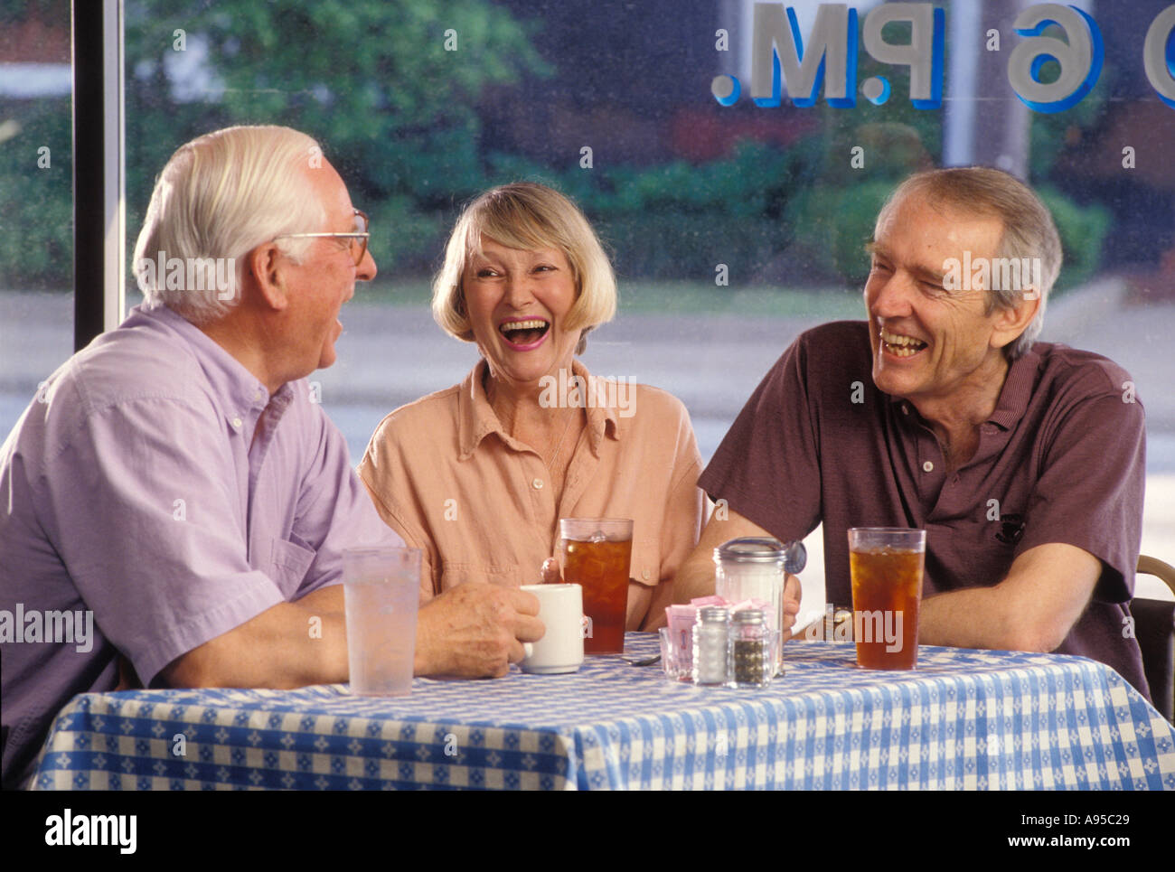 Seniors socialize at restaurant cafe Stock Photo - Alamy