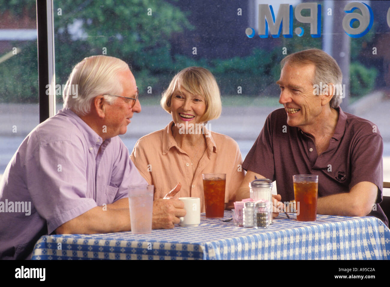 Seniors socialize at restaurant cafe Stock Photo - Alamy