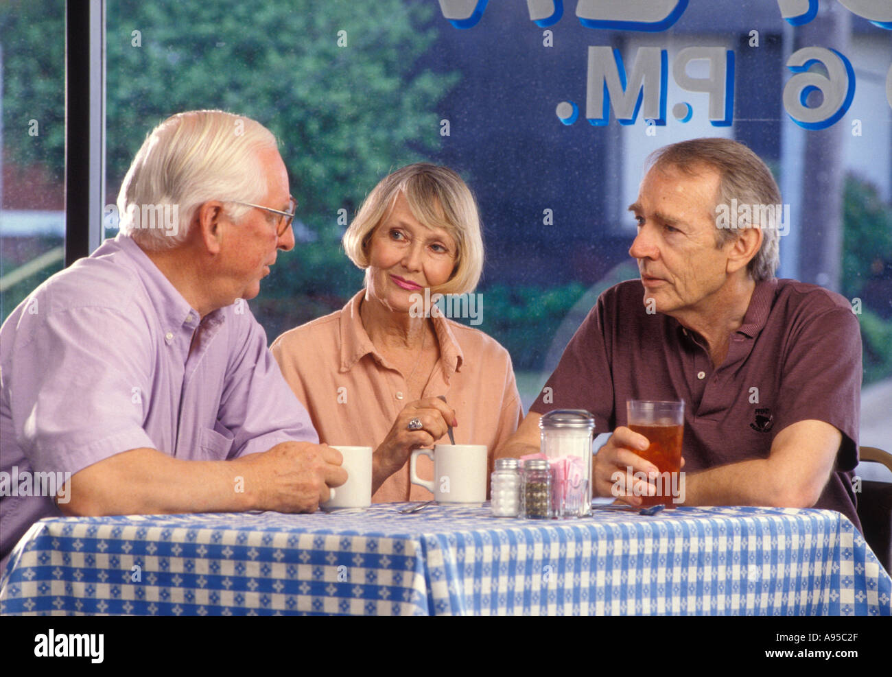 Seniors socialize at cafe Stock Photo - Alamy