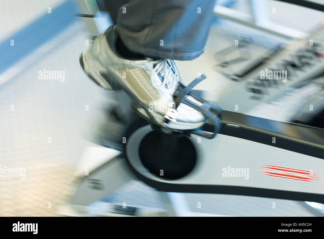 Person peddling exercise bike, close-up, blurred motion Stock Photo - Alamy