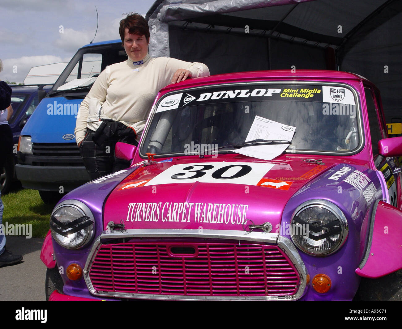 Driver with her Mini racing car at the motor racing circuit near the ...