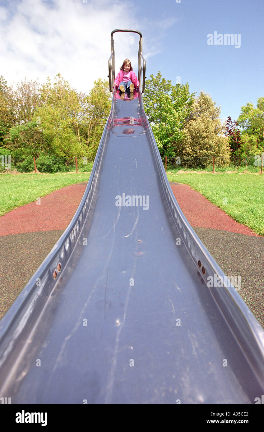 A young girl playing on a slide Stock Photo - Alamy