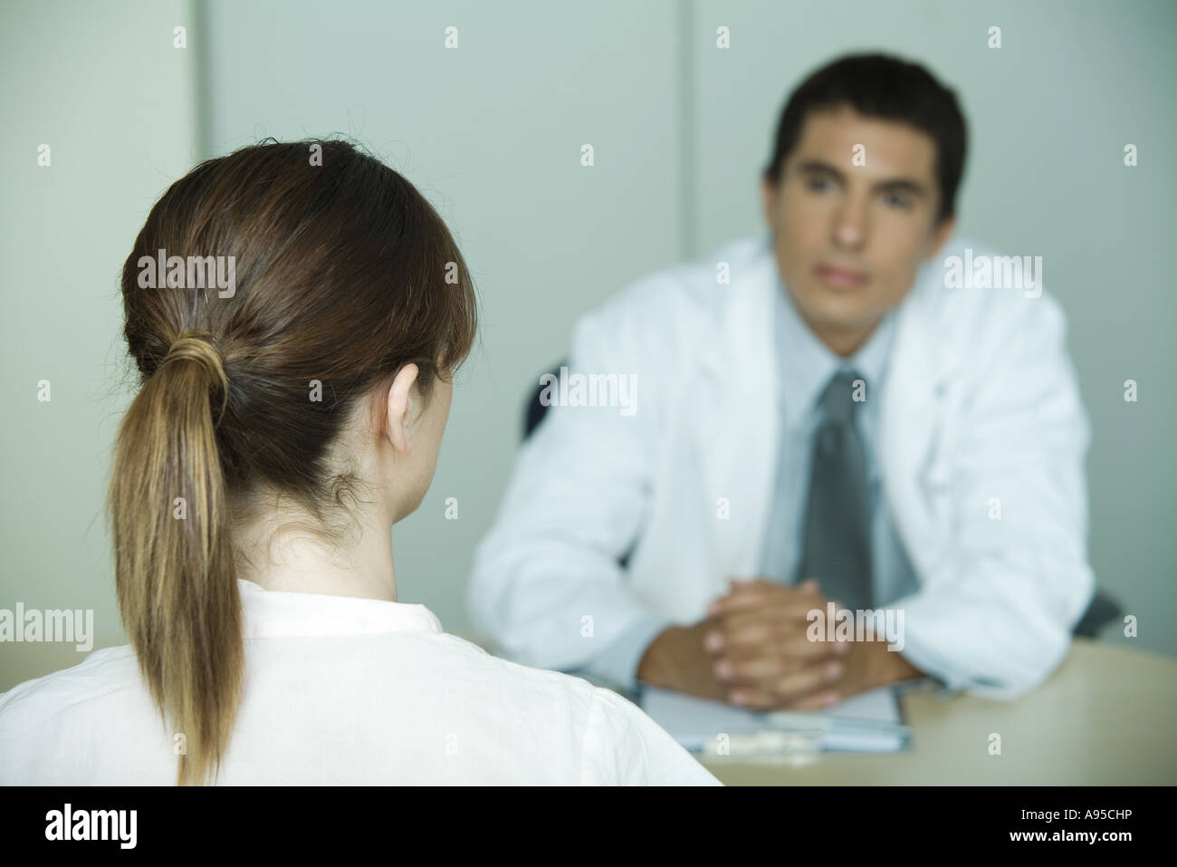 Doctor listening to patient Stock Photo - Alamy