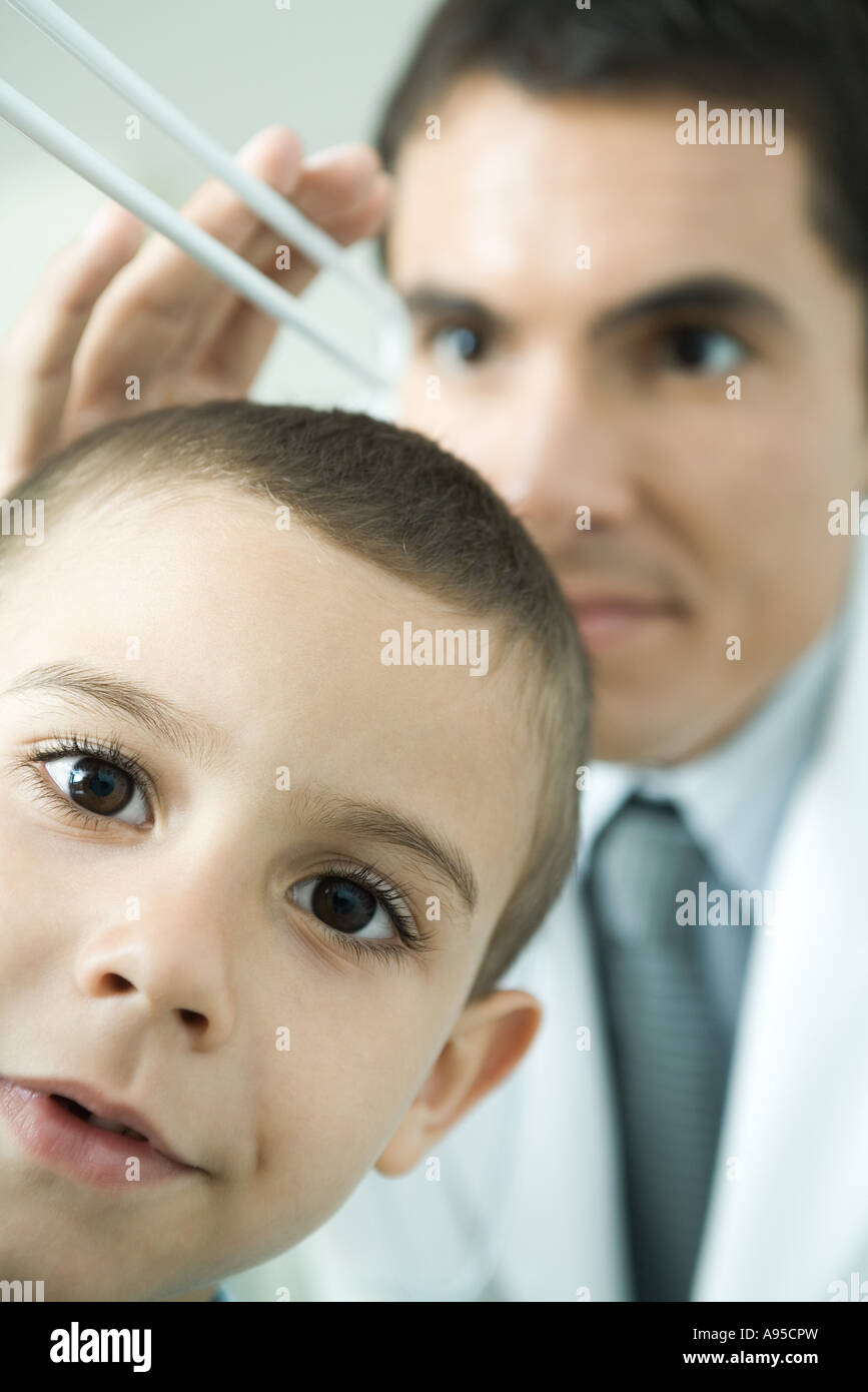 Doctor measuring boy Stock Photo - Alamy