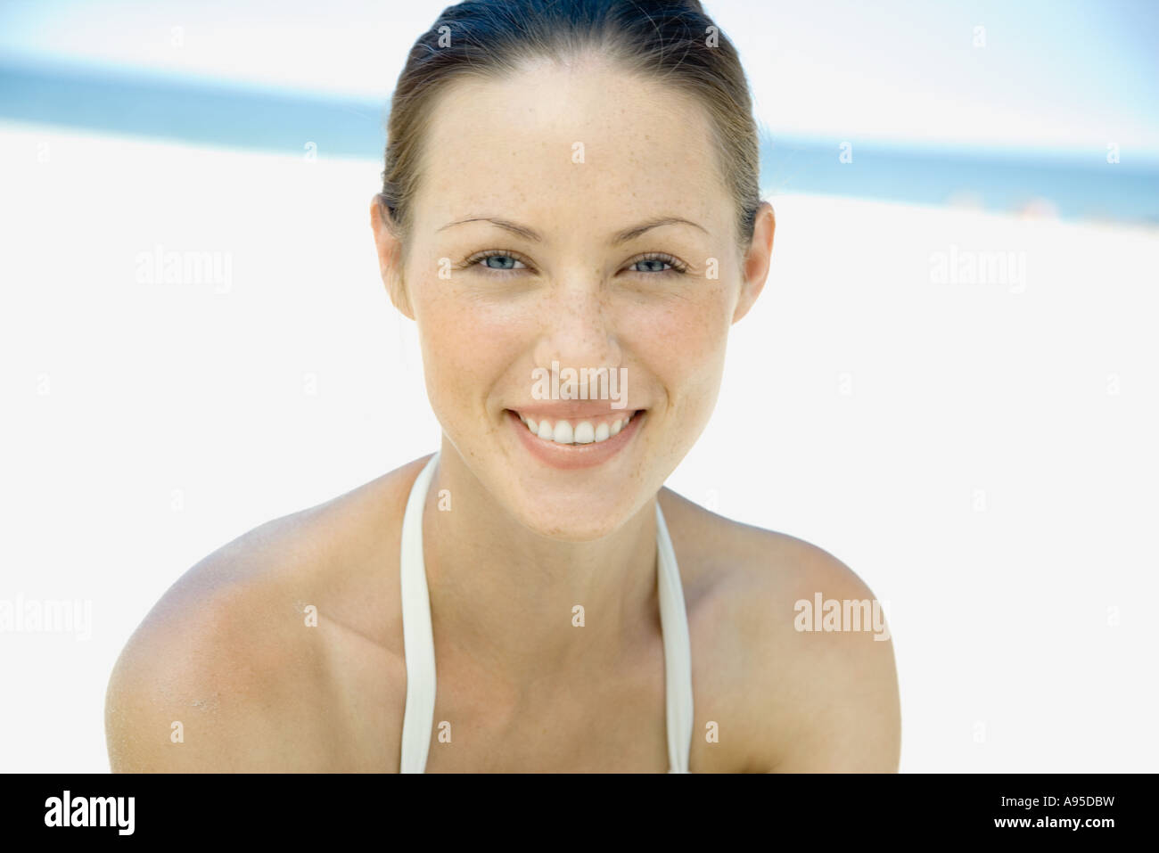 Woman on beach, smiling at camera, head and shoulders Stock Photo - Alamy