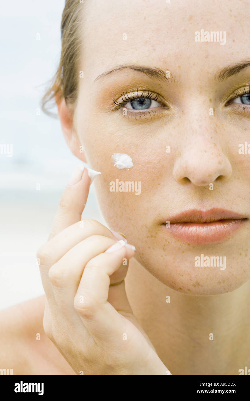 Applying sunscreen cropped woman young hi-res stock photography and ...