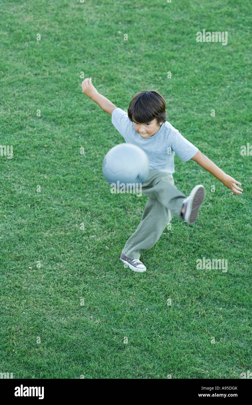 Boy kicking ball Stock Photo - Alamy